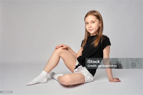 Full Length Portrait Of A Cute Girl Wearing White Shorts And Black