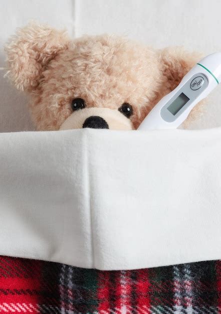 Premium Photo Fever Cold Flu Cute Teddy With A Thermometer In Bed