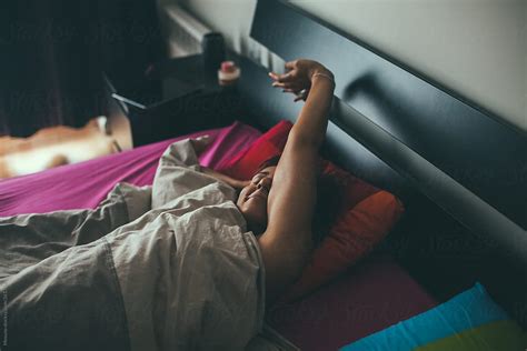 Stretching In Bed By Stocksy Contributor Mosuno Stocksy