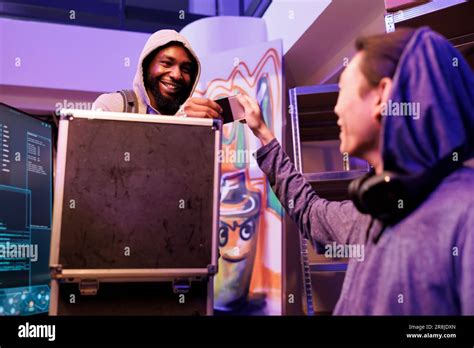 Smiling Hacker Bringing Ssd With Computer Virus In Abandoned Warehouse African American Malware