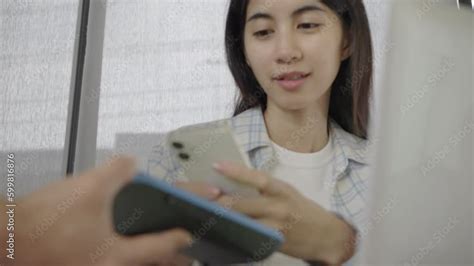 Babe Asian Woman Pays For Food Or Drinks Via Wireless POS Machine By Scanning 2D Bar Code Or QR