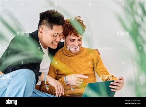 Man Pointing The Laptop Screen Next To His Gay Couple Stock Photo Alamy
