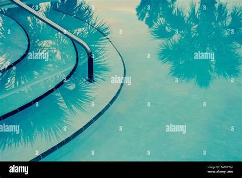 Teal Swimming Pool Still Life Shows Art Deco Style Steps With The Reflection Of Florida Palm