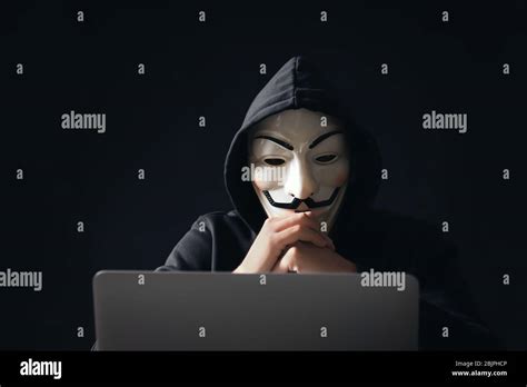 Hacker Anonymous Mask Using Laptop Hi Res Stock Photography And Images Alamy