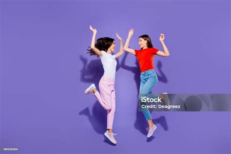 전체 길이 몸 크기 세로 두 좋은 사랑 스러운 재미 있는 펑키 부주의 평온한 사랑 스러운 매력적인 매력적인 명랑 소녀 들의 보라색 보라색 배경 위에 절연 공기에서 비행 위로