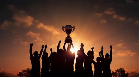 Winning Team With Gold Trophy Cup Against Shining Sun In Sky Premium