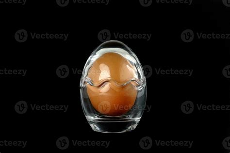 Egg In Egg Shape Glass Container Protection Shell On Black Background