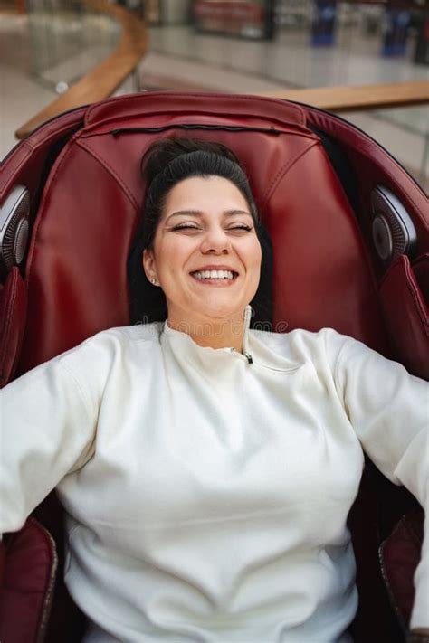 Relaxing Experience In A Contemporary Massage Chair At The Mall Stock