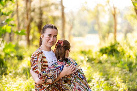 Image Of Happy Aboriginal Sisters Hug Outside In Morning Sunshine