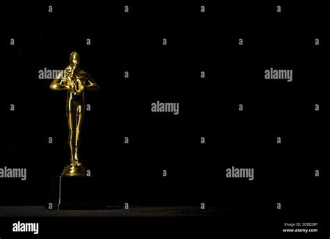 Hollywood Golden Oscar Academy Award Statue Against Black Background