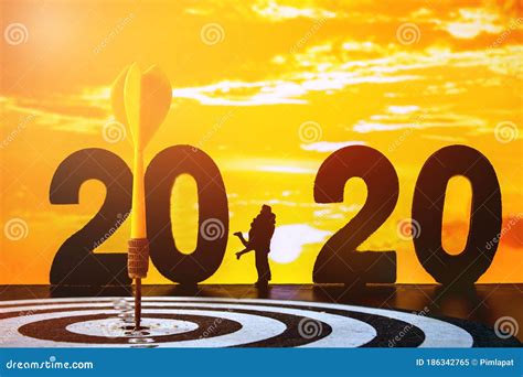 Old Dart Target With Arrows Over Silhouette Of Miniature Couple With Text Over Blurred