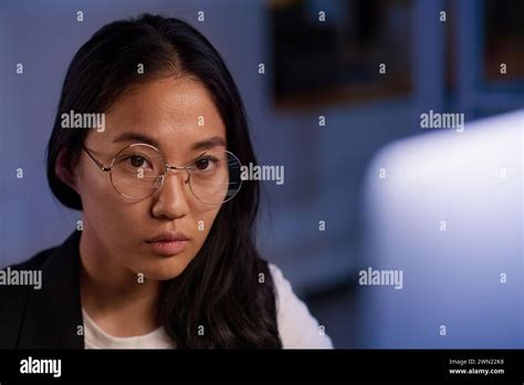 Close Up Portrait Of Asian Female Programmer Wearing Eyeglasses Working On Code At Workplace In