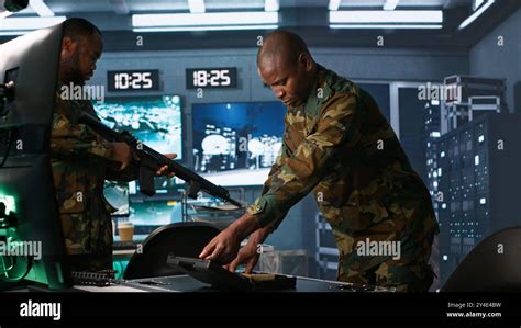 Military Officers Working Together To Check Guns In Command Post
