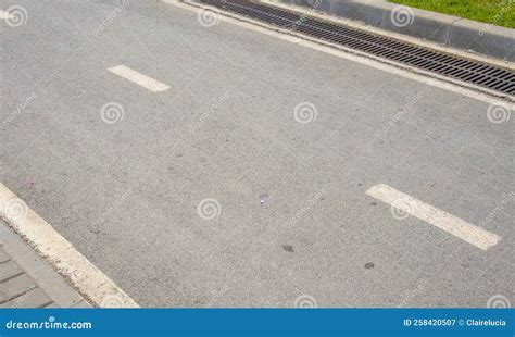 An Intermittent Lane Marking Line And The Direction Of Traffic On An Asphalt Road With A Copy Of
