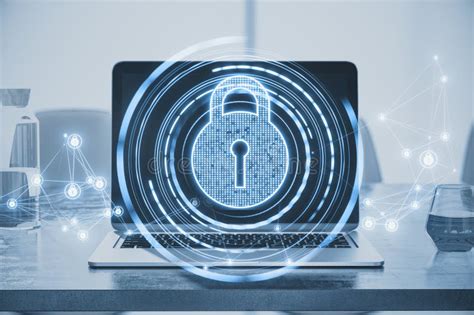 Close Up Of Laptop On Desk With Glowing Polygonal Padlock Hologram On Blurry Window With City