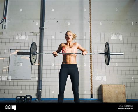 Young Strong Woman Practices Cross Fit In A Gym Fit Female Holding A