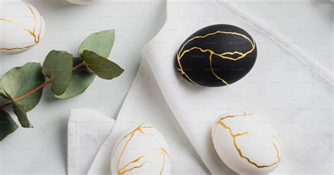 우아한 부활절 플랫 레이 구성 세련된 부활절 달걀은 대리석 테이블에 금 토끼 토끼 유칼립투스 잎으로 장식되어 있습니다 평면도 최소한의 스타일 사진