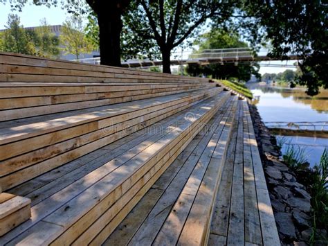 A Floating Jetty For Mooring Ships Is Fixed With Metal Rods On Hinges Wooden Stairs Are Benches