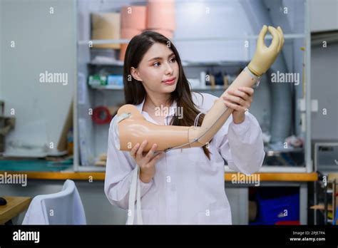 Prosthetic Technician Holding Prosthetic Arm Checking And Controlling