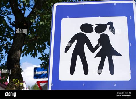 The Road Sign Is A Place For Kisses In Blue With The Image Of Silhouettes Of Opposite Sexes