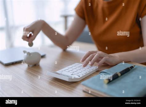 Woman Creates A Detailed Financial Saving Plan Using A Calculator To Organize Her Expenses And