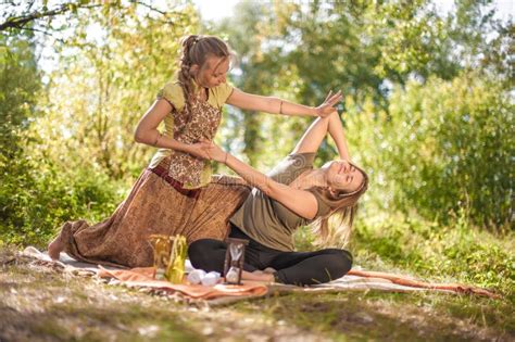 Girl Masseuse Demonstrates Refreshing Massaging Methods In A Forest