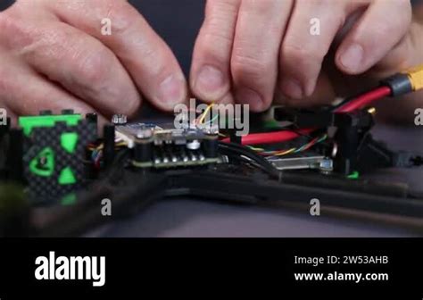 Close Up Of Man S Hands Assembling A Drone From Parts Using Tools Preparing High Speed Racing