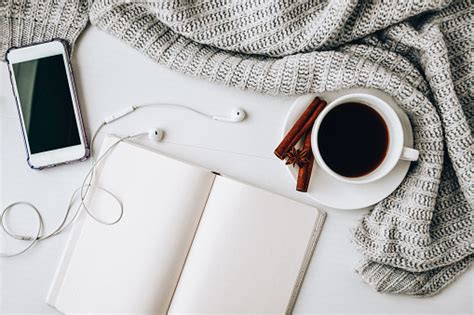 노트북 폰 헤드폰 계피 스틱과 흰색 배경에 아니스 스타커피 한 잔 스웨터 주위에 겨울 아침 루틴 공간을 복사합니다 맨 위 보기입니다 플랫 레이 0명에 대한 스톡 사진 및