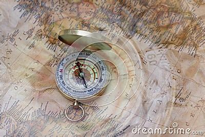 Antique Brass Compass Resting On A World Map Symbolizing Travel And