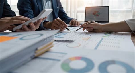 Business Team Analyzing Income Charts And Graphs With Modern Laptop