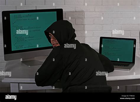 Hacker With Computer And Laptop Stock Photo Alamy