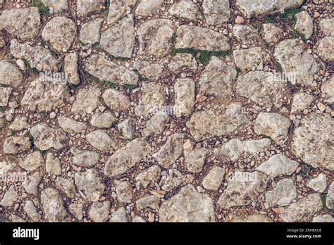 Top View Of Rough Stone Path Fragment With Textured Surface In Daytime