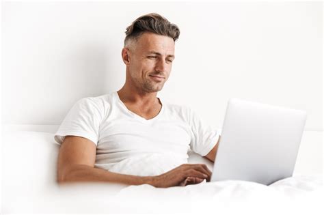 Premium Photo Smiling Man Using Laptop Computer