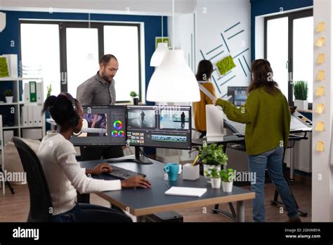 African American Video Editor Wearing Headset Editing Movie Using Post Production Software