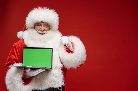 쾌활한 산타 클로스는 화면에 크로마 키가있는 노트북을 보여주는 몇 가지 성공을 축하합니다 산타 클로스에 대한 스톡 사진 및 기타 이미지 산타 클로스 노트북 백화점