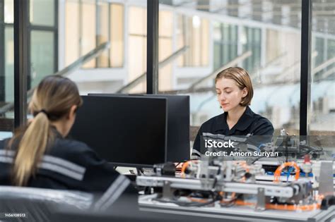 two female engineer discuss training ai robot training kit and