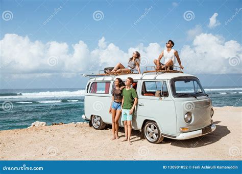 Hipster Girl Relaxing with Friends on the Retro Van Roof Stock Photo ...