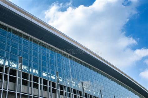 Modern Architecture Curved Building With Glass Decorations And Cool Tones Isolated Against A