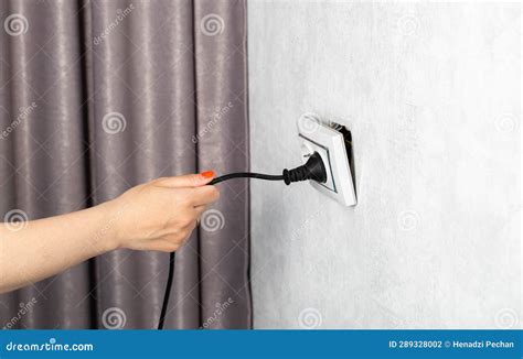 The Girl Incorrectly Removes The Electric Plug From The Socket And Breaks The Socket Danger Of