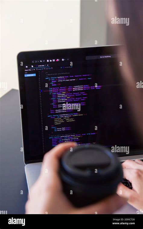 A Programmer Coding On A Laptop In The Workplace Stock Photo Alamy