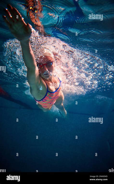 Dynamics Young Sportive Woman Professional Swimmer Training In Swimming Pool Indoor Wearing