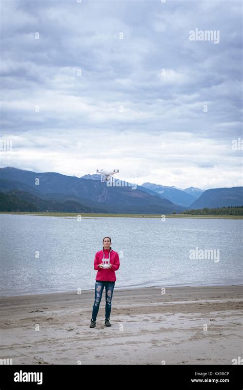 Woman Operating Drone Flying By Remote Control Stock Photo Alamy