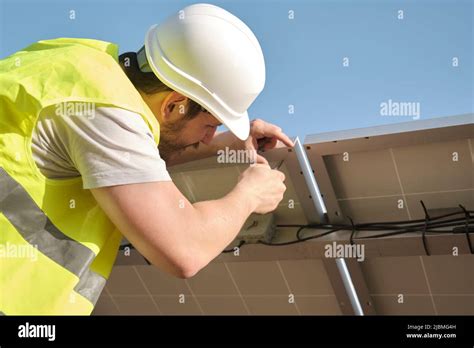 Young Technician Installing Solar Photovoltaic Panel Station Stock