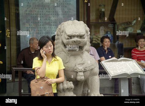 Chinese Girl Using Mobile Phone In Shanghai Stock Photo Alamy