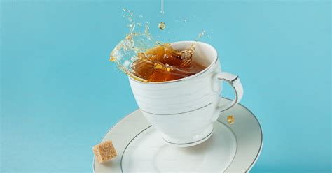 티백 레몬 설탕이 파란색 배경의 컵에 튀는 차 위에 밧줄에 매달려 있습니다 창조적 인 정물 사진 Unsplash의 다도 이미지