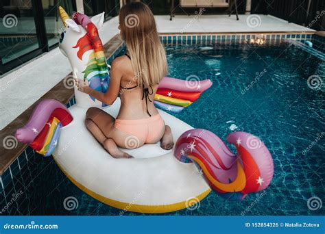 Woman Relaxing On The Unicorn In A Swimming Pool Stock Photo Image Of Poolside Pretty