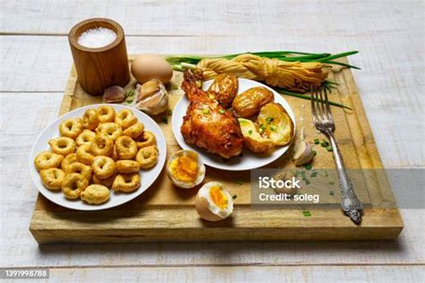 시골 스타일 건강한 음식 맥주 한 잔 튀긴 닭고기 고기 및 껍질을 벗기지 않은 감자 계란 녹색 부추 소금 및 마늘 흰색 나무 보드에 요리 한 음식 감자 요리에 대한 스톡