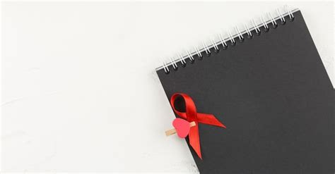 Premium Photo Black Notepad With Red Ribbon As Sign Of Cancer
