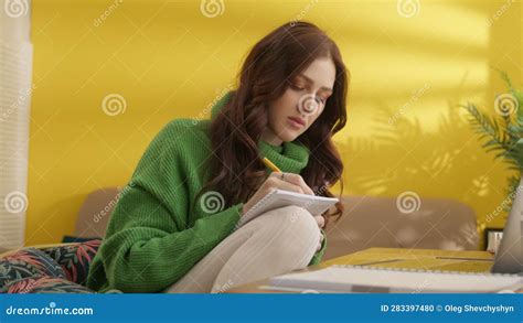 Cute Female Babe Making Notes Using Information From Laptop Home Room Stock Footage