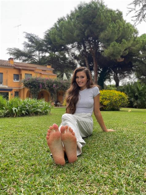 Teen With Bare Feet Sitting In The Grass Showing Gorgeous Soles